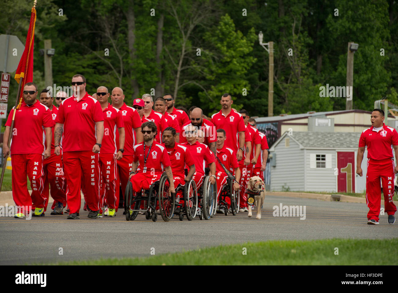 Marine Corps team members march to their seats during the opening ...