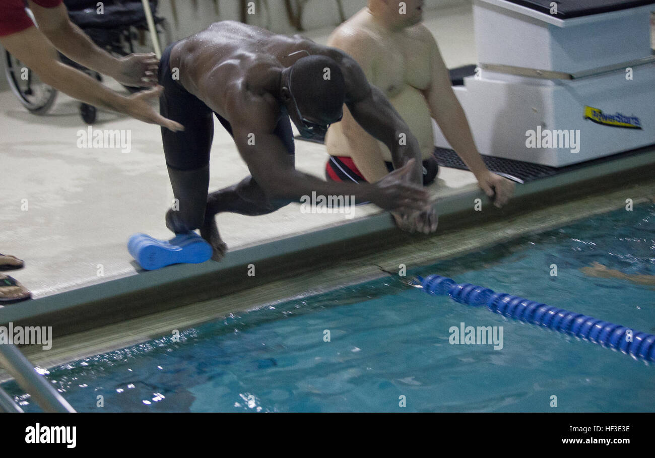 U.S. Marine Corps veteran Kionte Storey dives into the pool during a ...