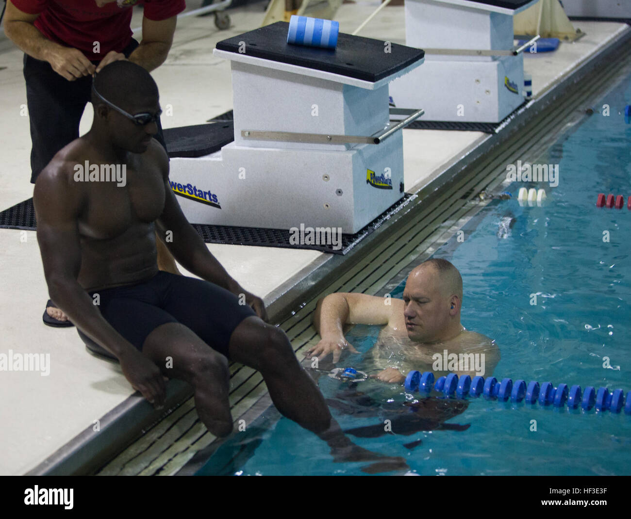 U.S. Marine Corps veteran Kionte Storey, left, sits by the pool during ...