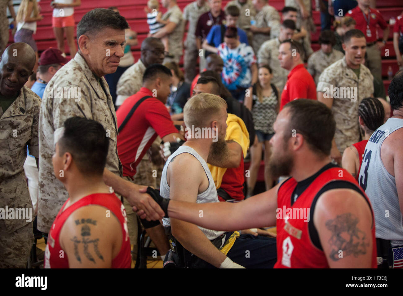 U.S. Marine Corps veteran Clayton McDaniel, right, shakes hands with ...