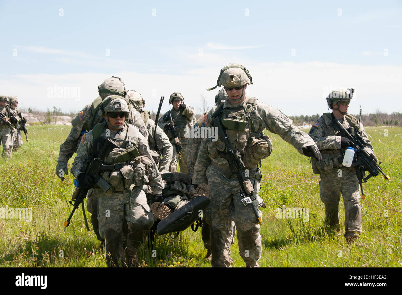 A U.S. Army team conducts casualty movement during live-fire training ...