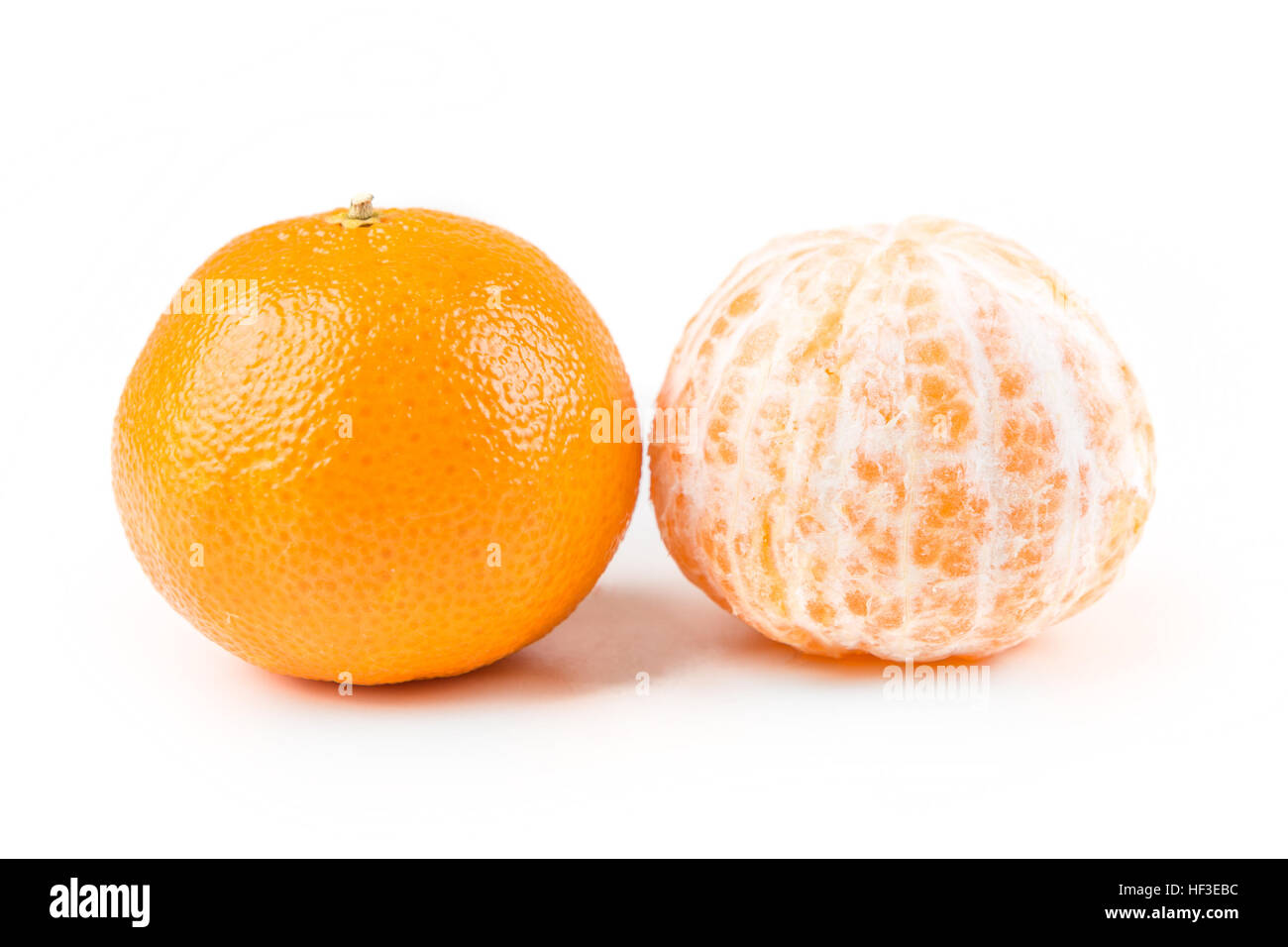 Two navel oranges one peeled one unpeeled isolated on white background ...