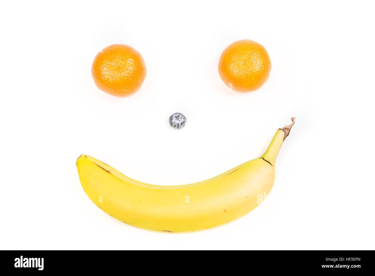 Happy fruit face with banana, blueberry and oranges isolated on white ...