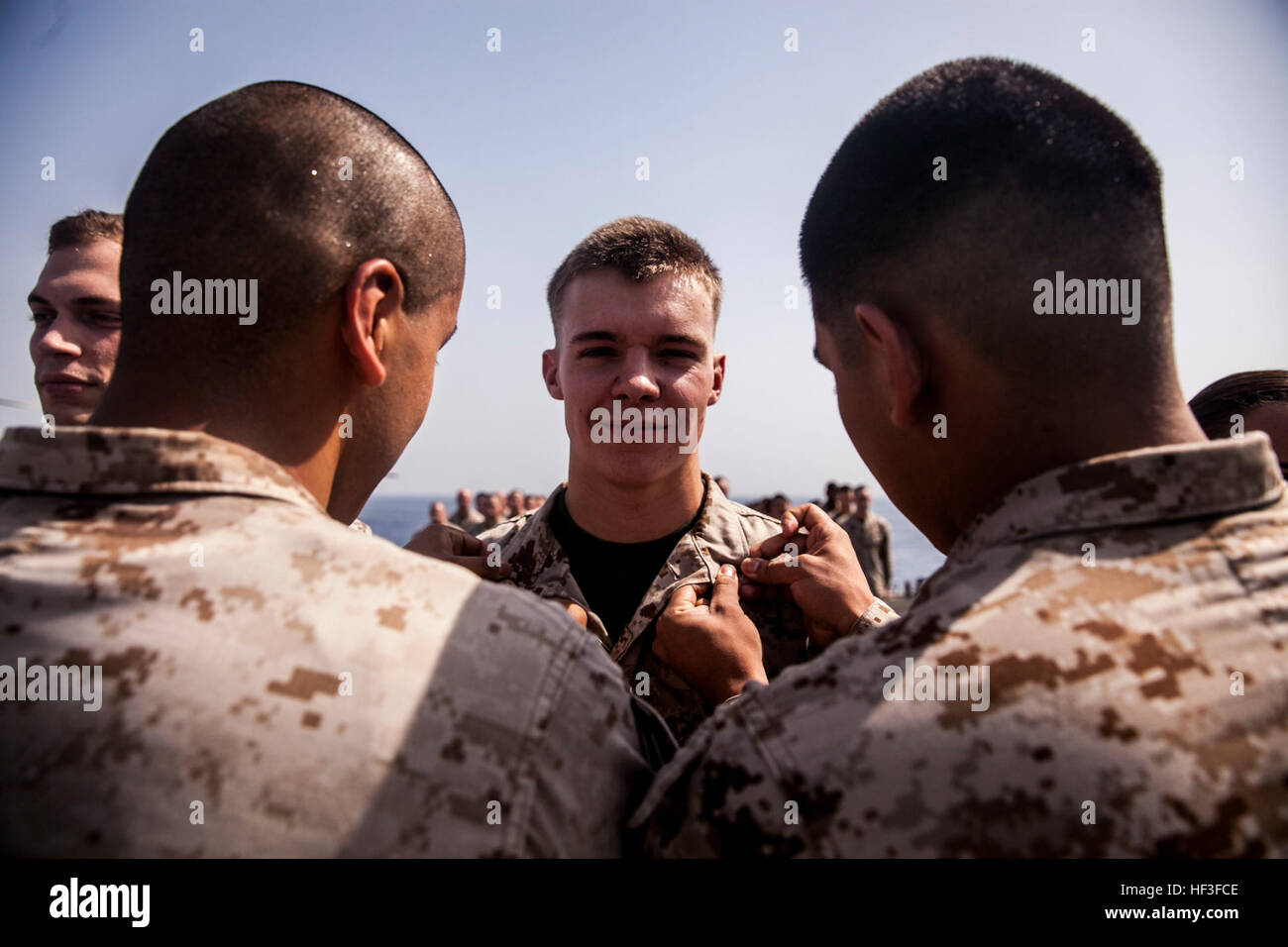 U.S. Marine Cpl. Ian Eckelberg is pinned by his fellow Marines from the ...