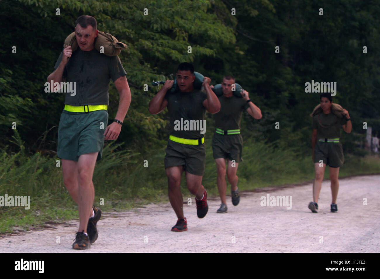 Marines with Marine Wing Support Squadron 274 carry 35-pound sandbags ...