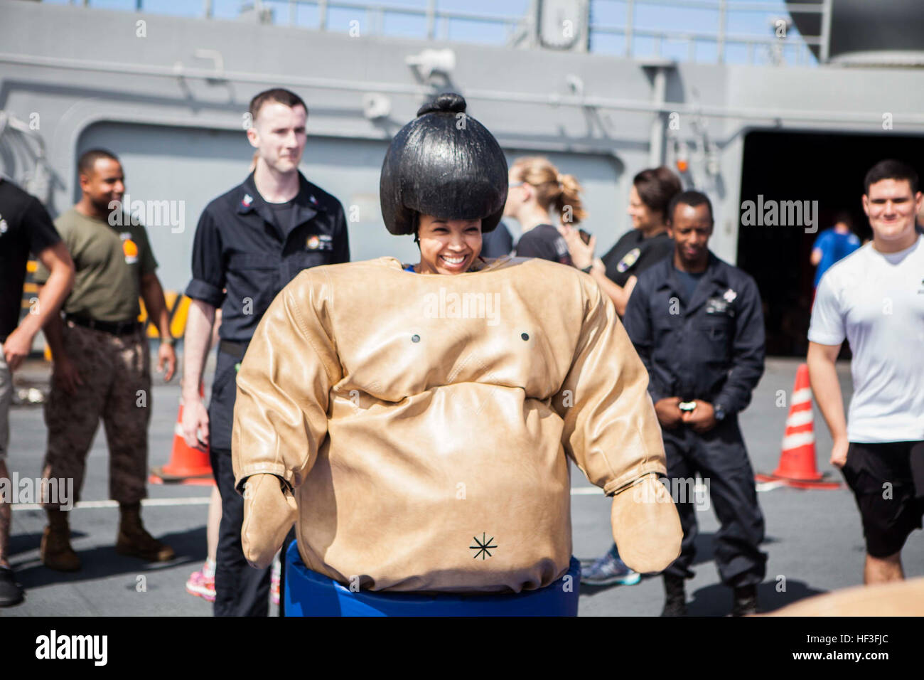 A Navy sailor participates in sumo suit wrestling during the Fourth of ...