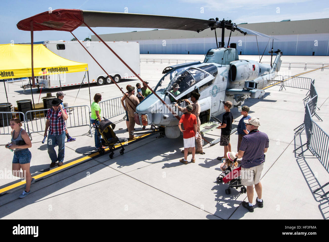 Service members and their families tour a AH-1W Super Cobra assigned to ...