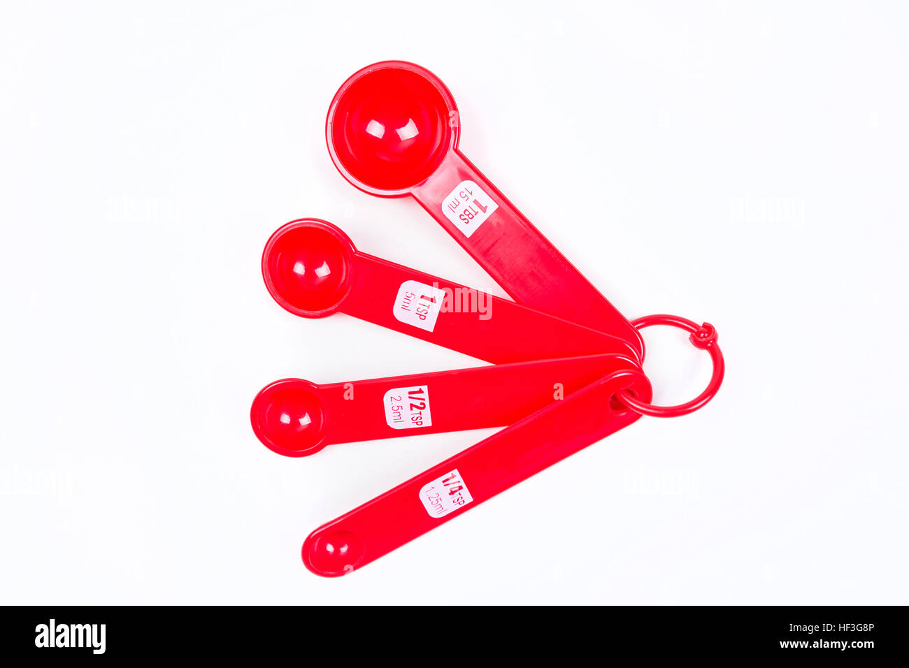Red measuring spoons isolated on white background Stock Photo - Alamy