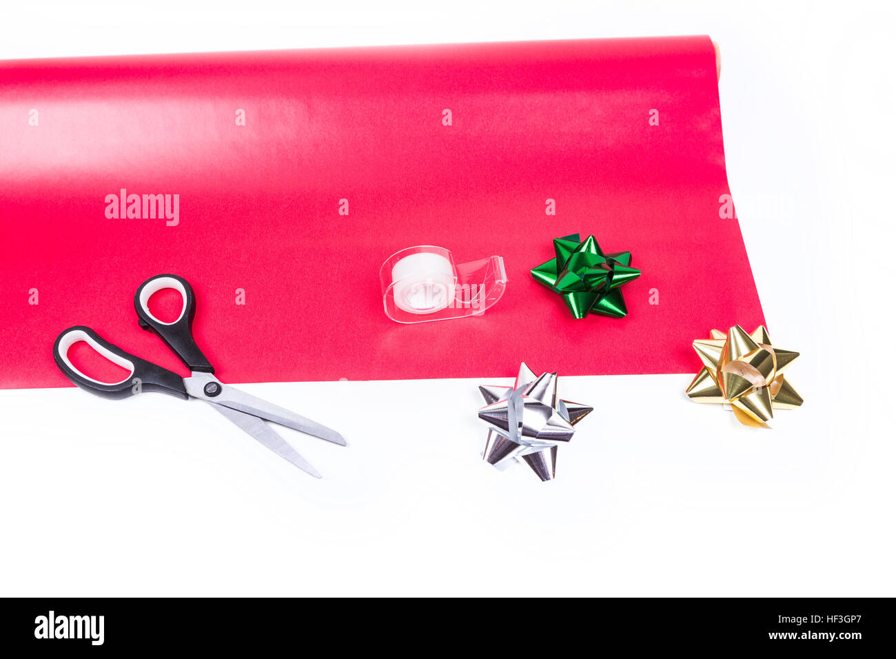 Wrapping paper, scissors, tape and bows isolated on white background ...