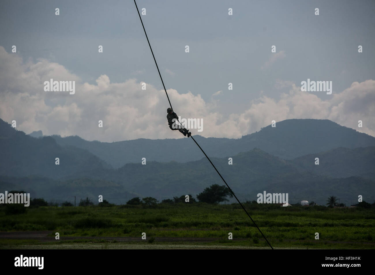A Philippine Marine fast ropes out of a MV-22B Osprey while U.S ...