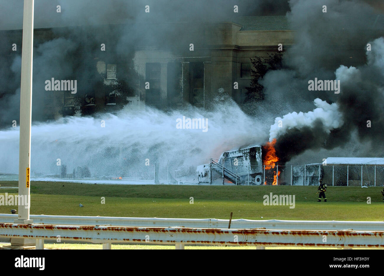 Firefighters work to put out the flames moments after a hijacked ...