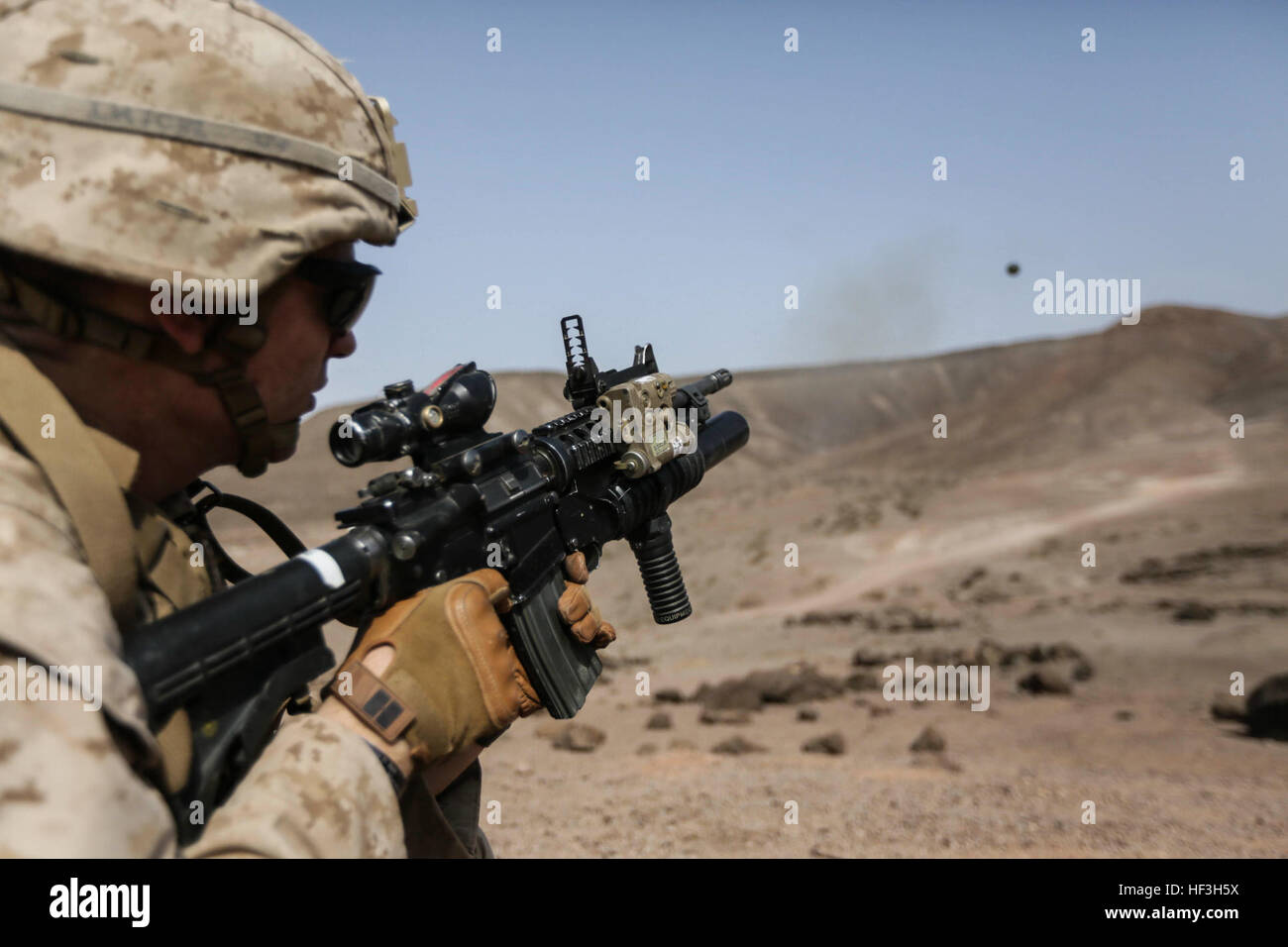 U.S. Marine Lance Cpl. fires an M203 grenade launcher during grenade ...