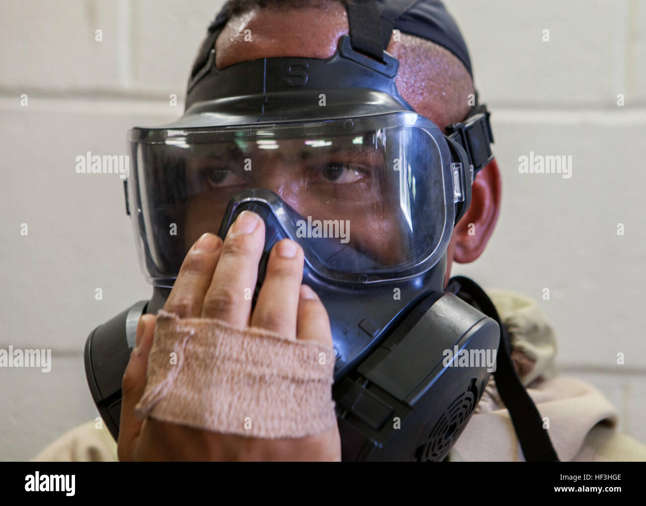 A Midshipman clears his M50 joint service general purpose mask while ...