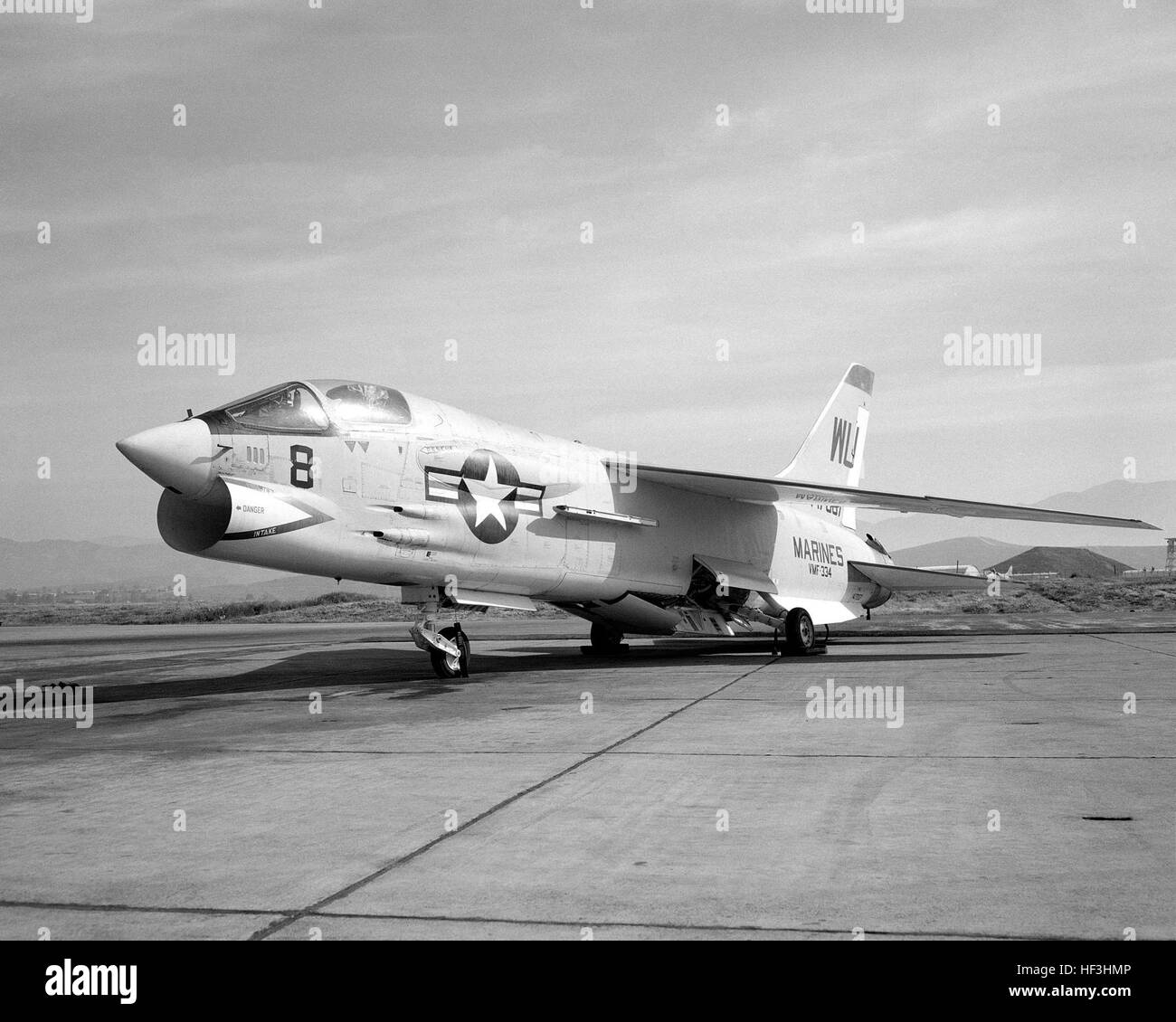 A left front view of an F-8C Crusader aircraft parked on the flight ...