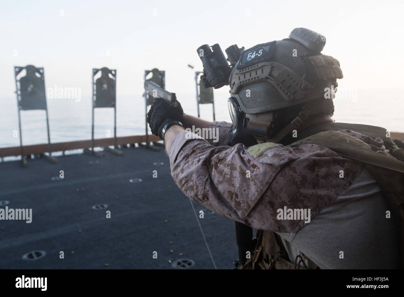 A U.S. Navy special amphibious reconnaissance corpsman engages a target ...