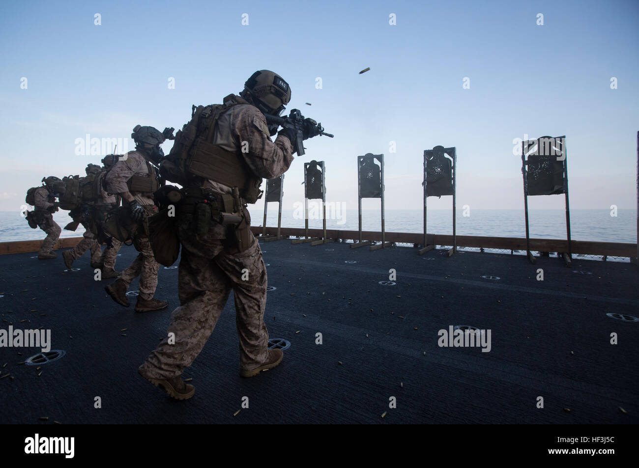 Reconnaissance Marines close with their targets while firing during a ...