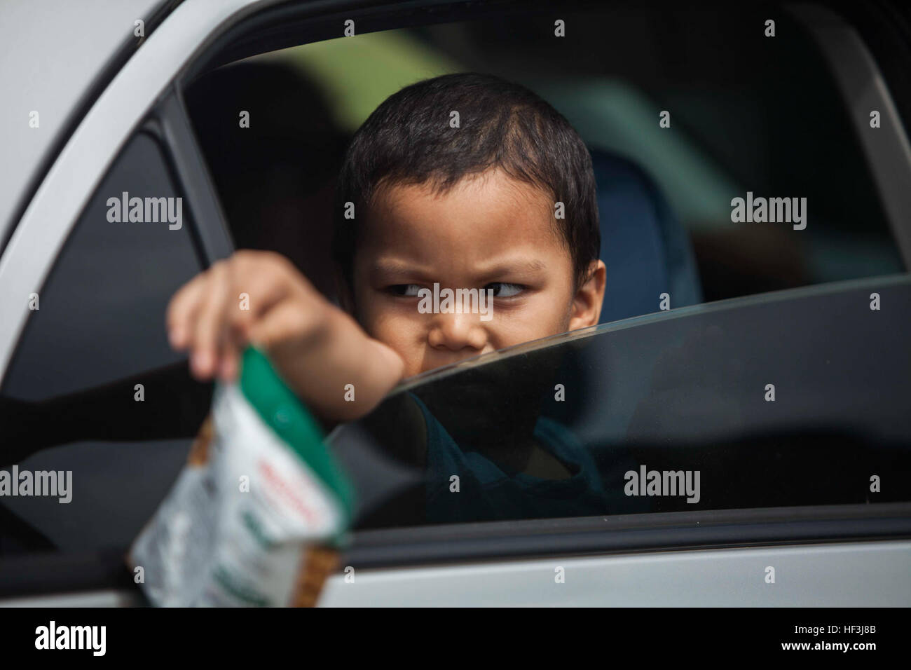 A young boy offers some snacks to U.S. Marines with Combat Logistics ...