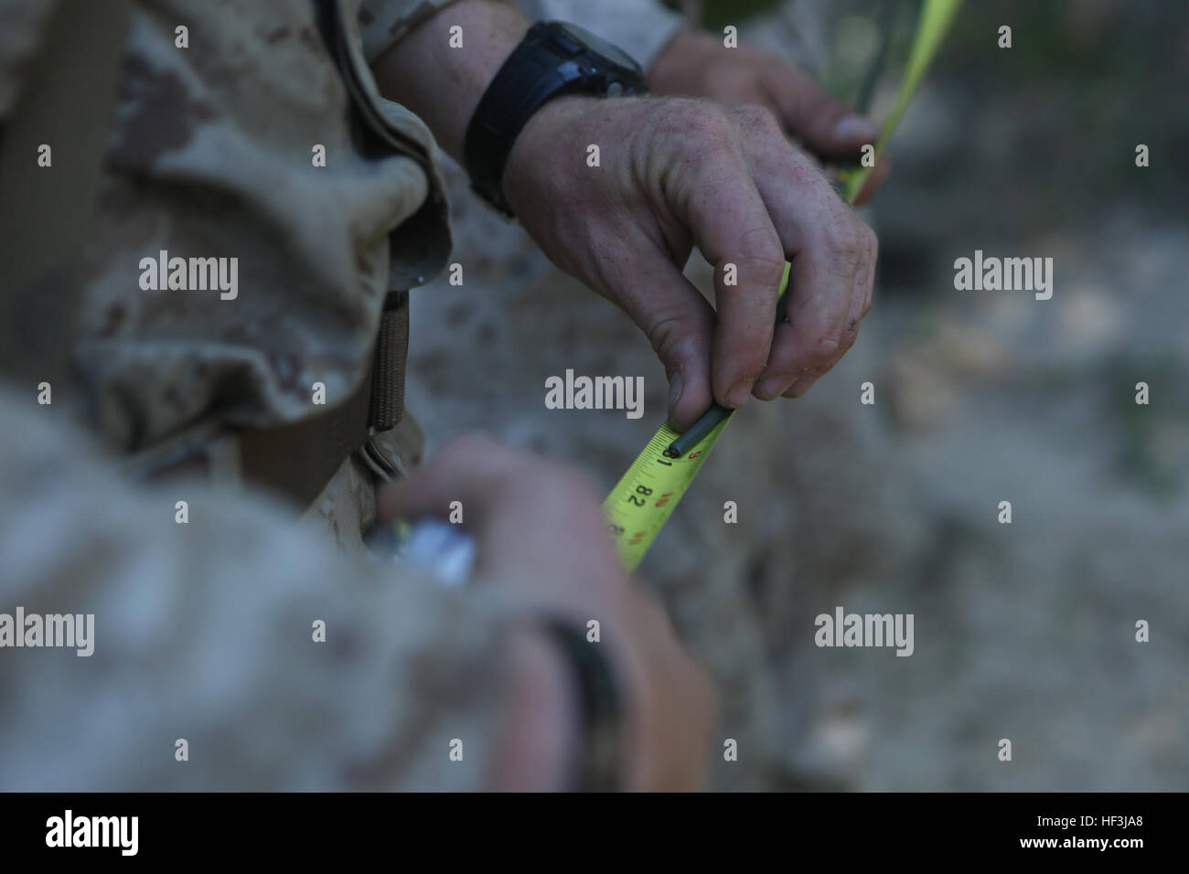 Marines from 2nd Combat Engineer Battalion measure a strand of ...