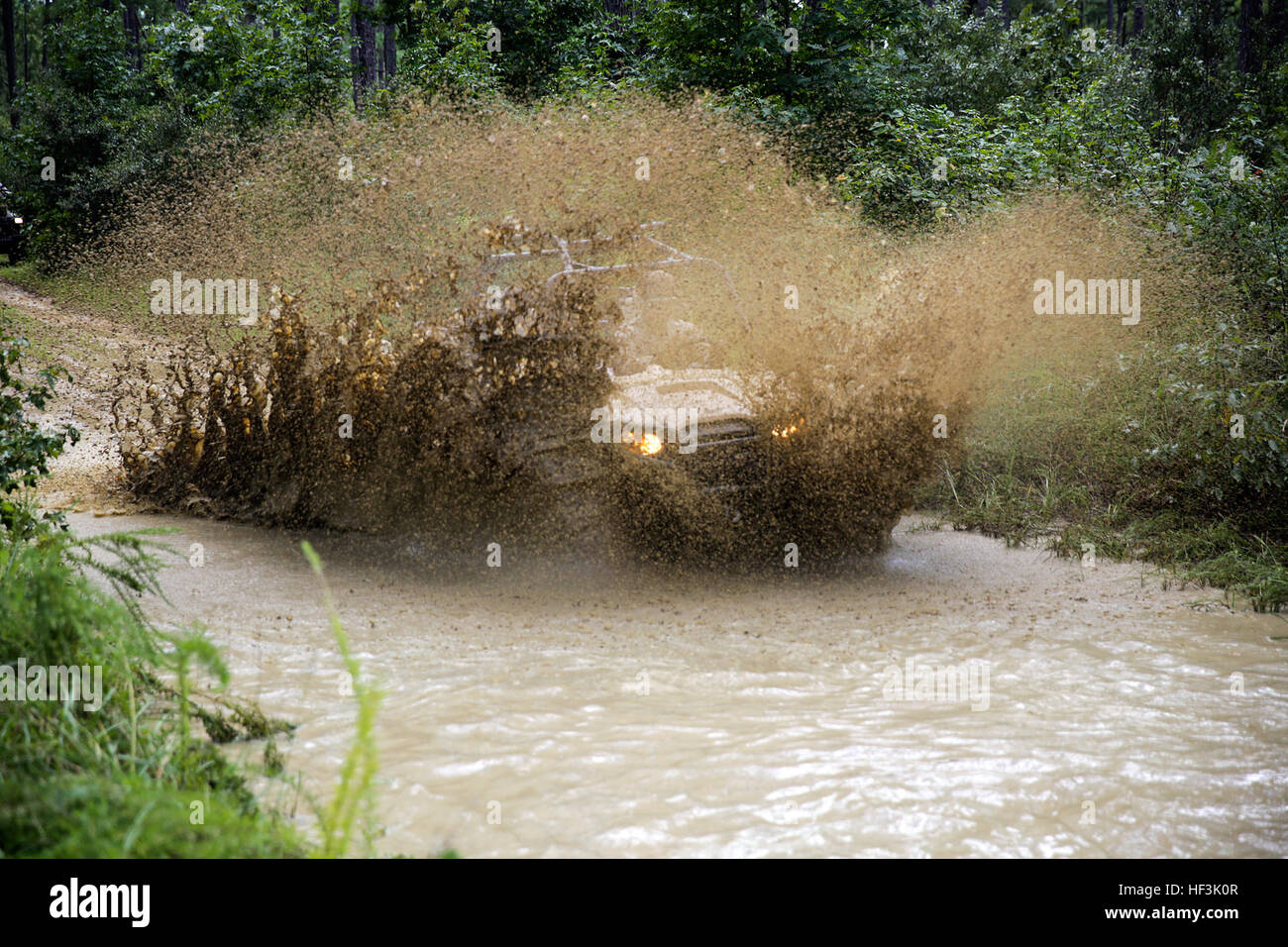 A Marine with Alpha Company, 2nd Reconnaissance Battalion drives and ...
