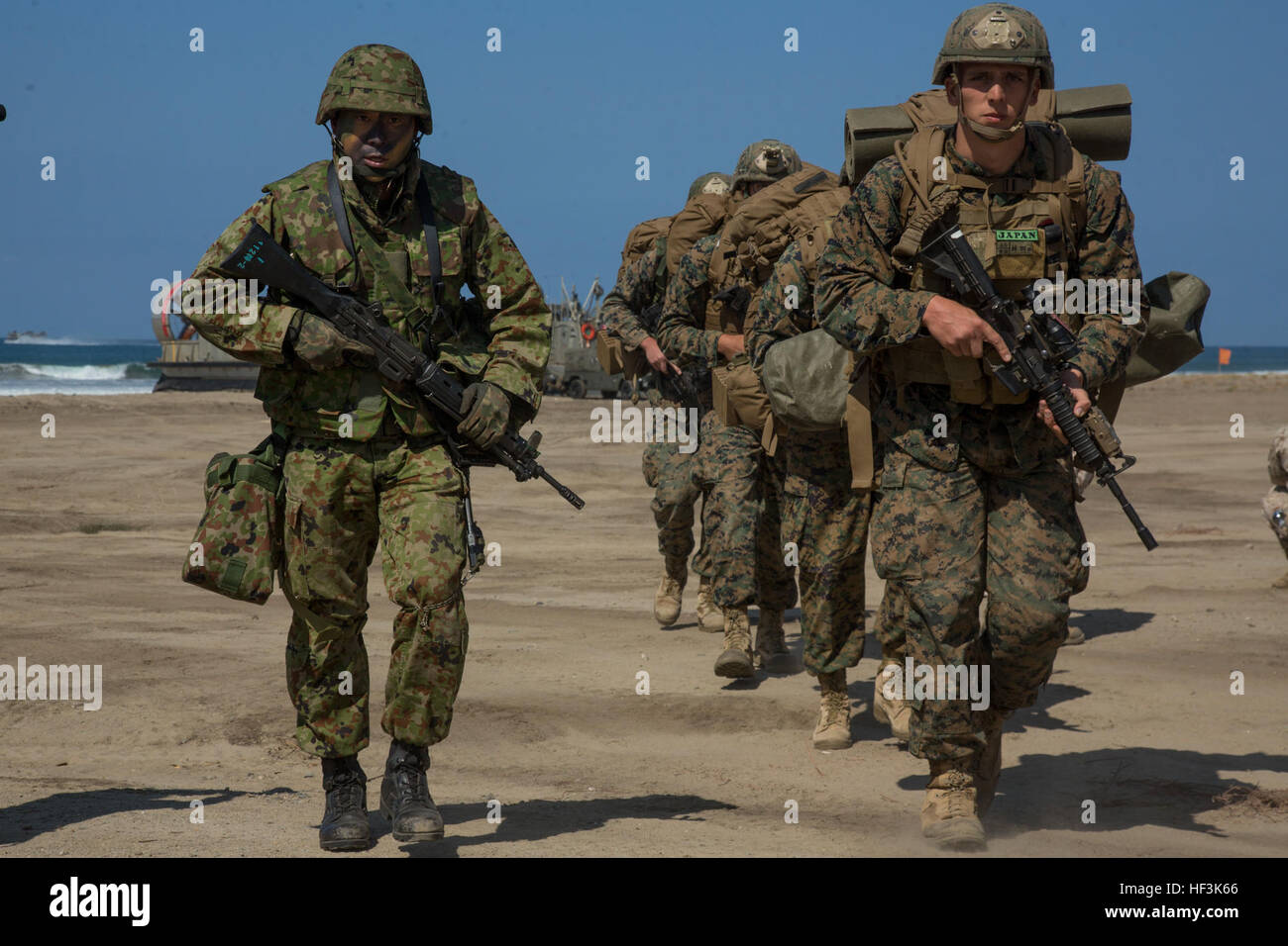 U.S. Marines and a Japanese Ground Self Defense Force solider offload a ...