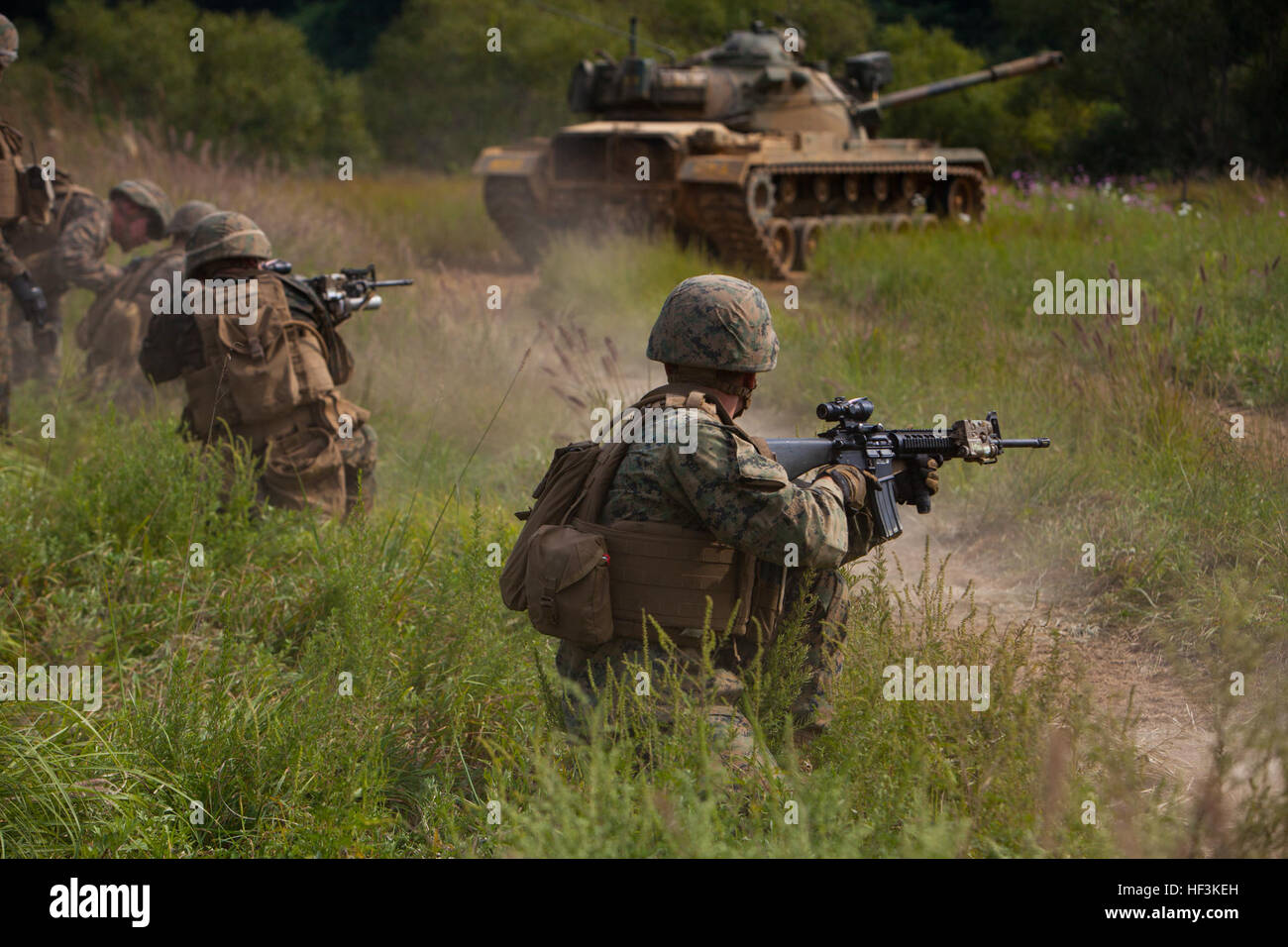 U.S. Marines shoot and move toward a target during integrated live fire ...