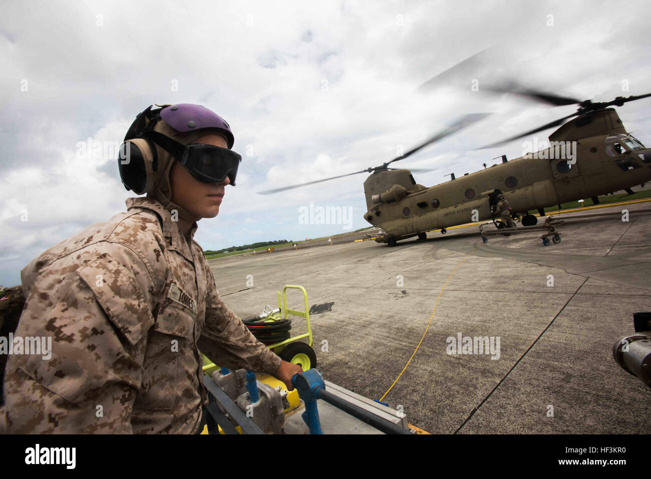 A U.S. Marine with Headquarters Battalion, MCB Hawaii, refuels an Army ...