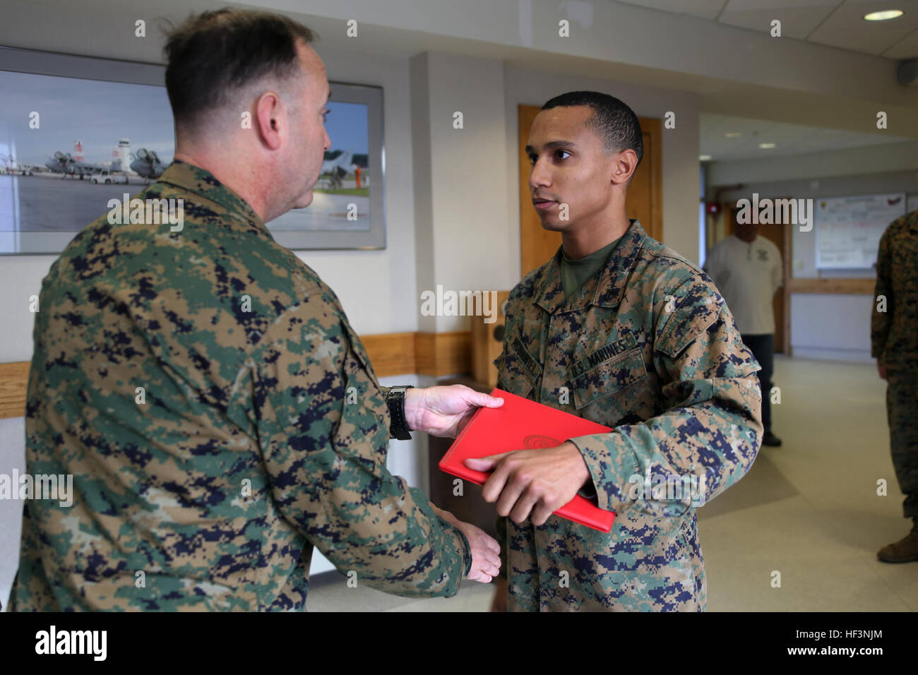 Cpl. Justin McDaniel accepts the Navy and Marine Corps Achievement ...
