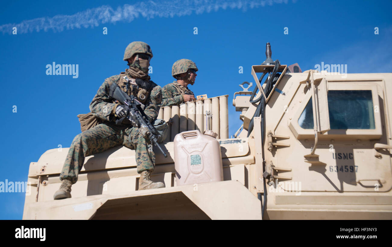 Marines hold security during maintenance on a mine resistant ambush ...