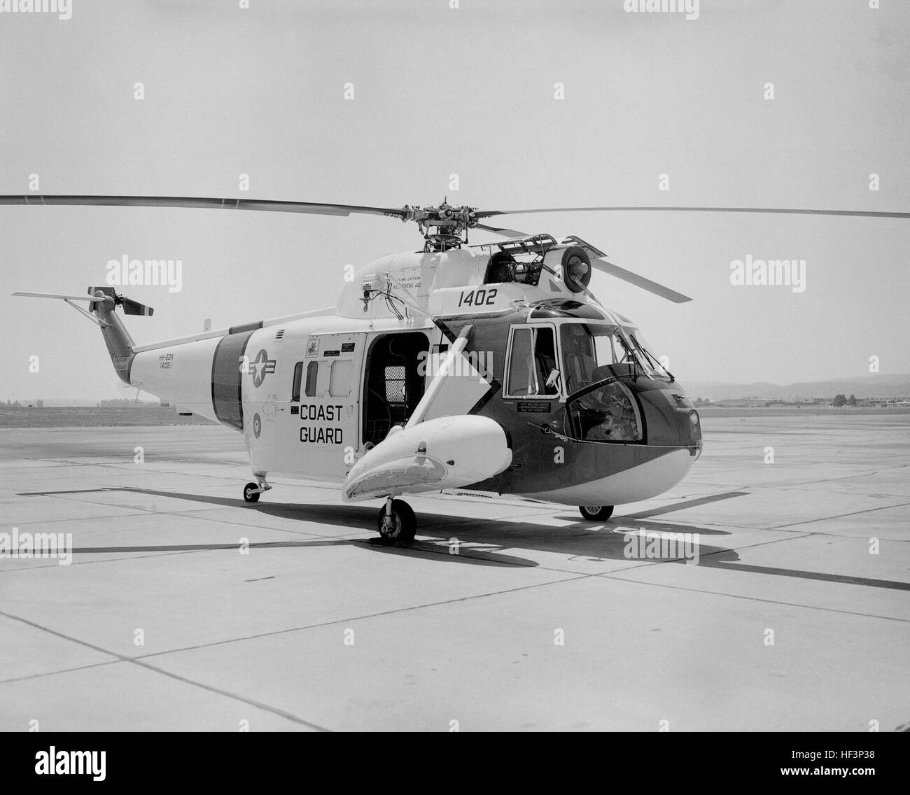 A U.S. Coast Guard HH-52A Sea Guard helicopter is parked on the flight ...