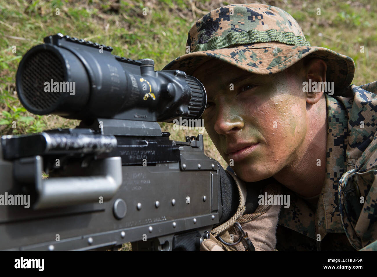 Lance Cpl. Jonathan Gilbert looks through the scope of his M240 medium ...