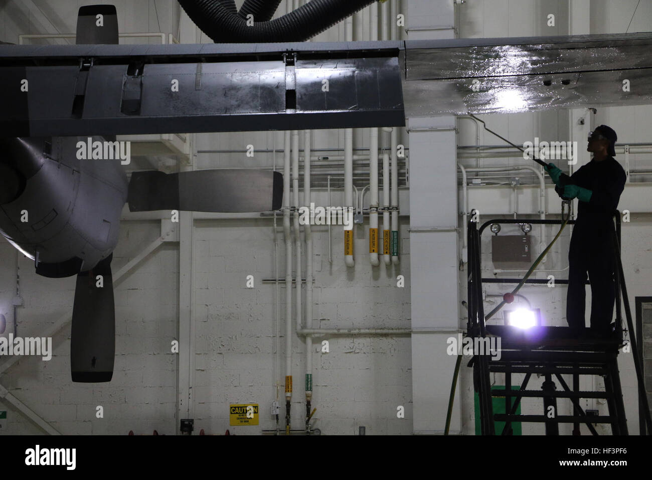 Master Sgt. Kristopher Wolf rinses the wing of a C-130H Hercules at the ...