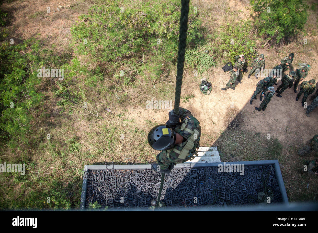 A Royal Thai Marine slides down a rope as they practice fast rope ...