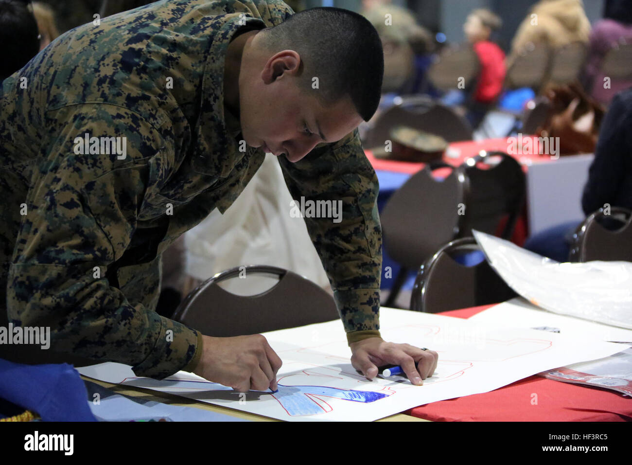 Lance Cpl. Freddy Flores makes a welcome home sign for returning ...