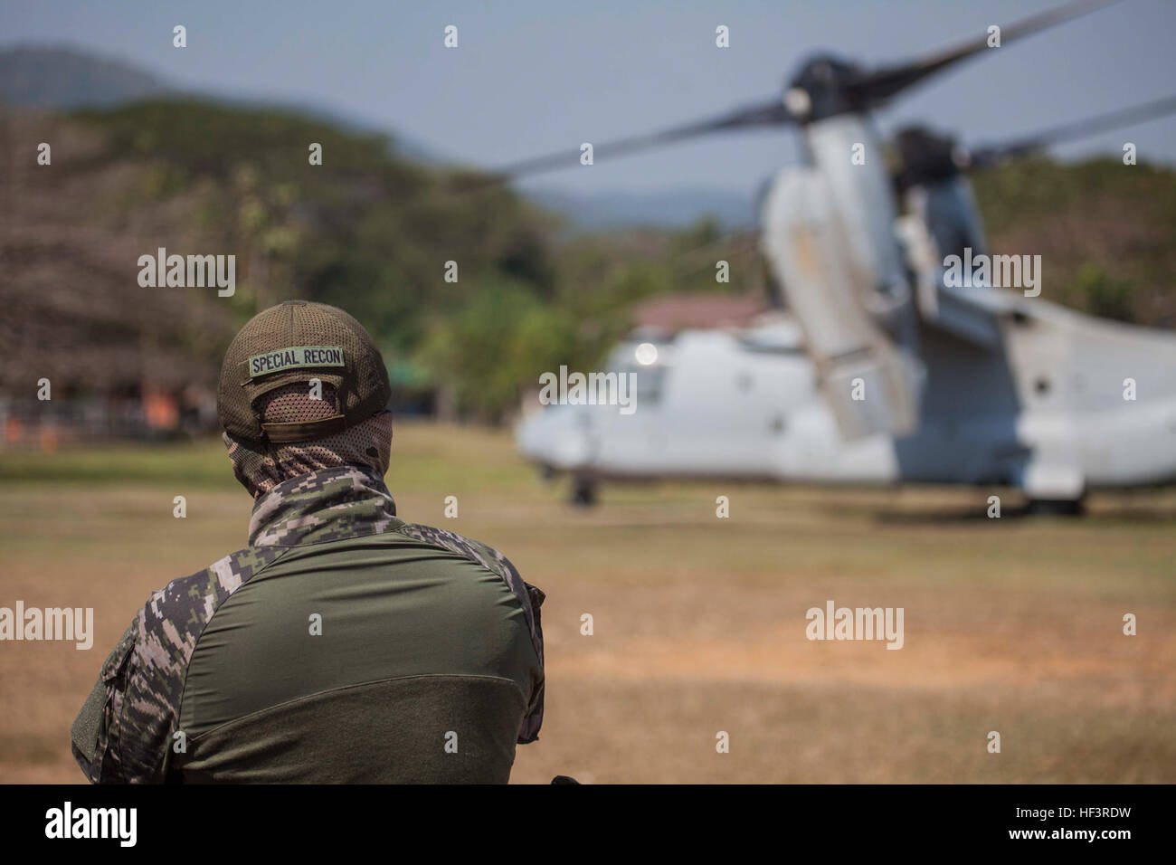 A Republic of Korea Marine observes as an MV-22 Osprey prepares to take ...