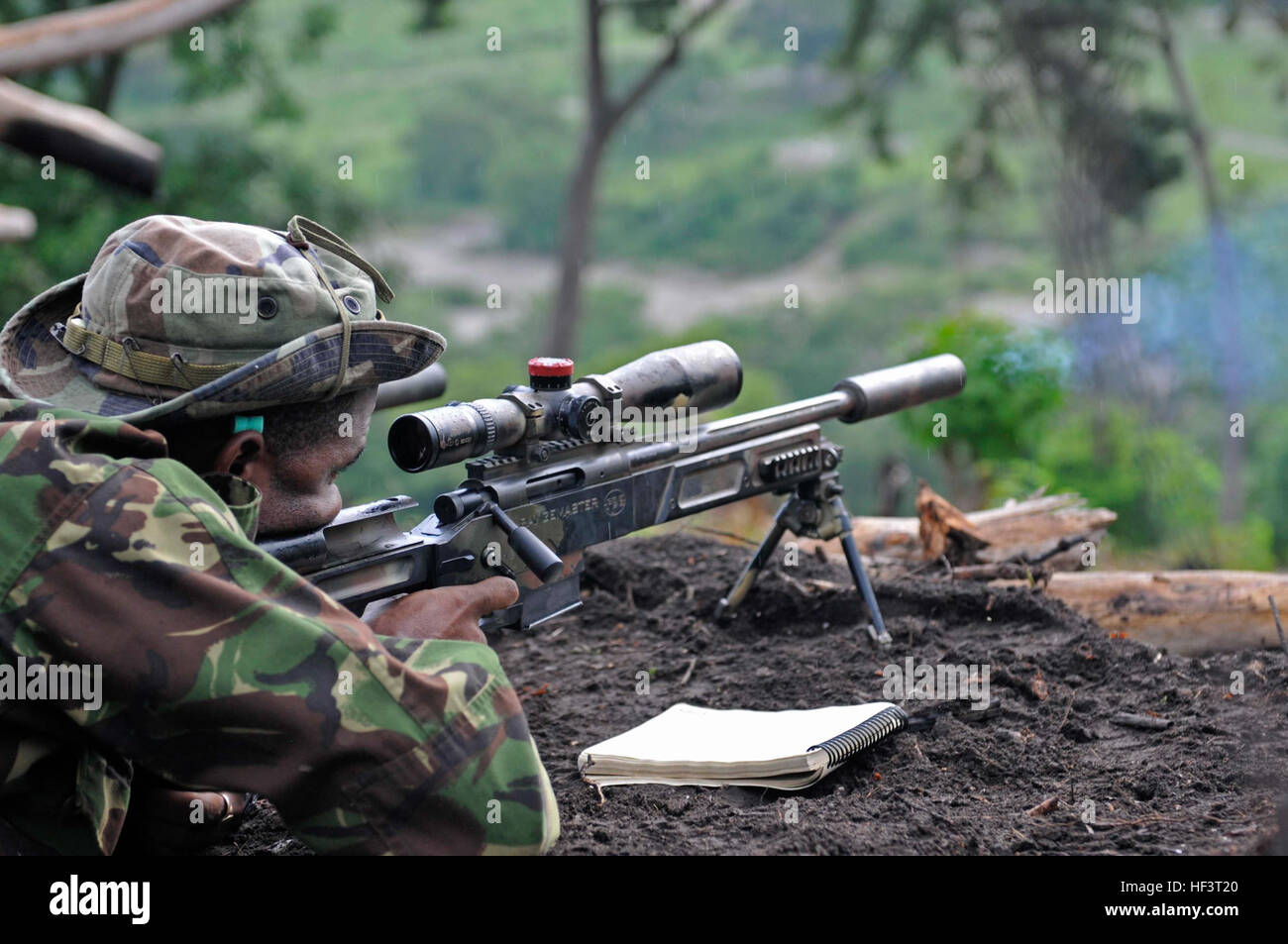 A sniper from the Brazilian team fires a round at a target during the ...