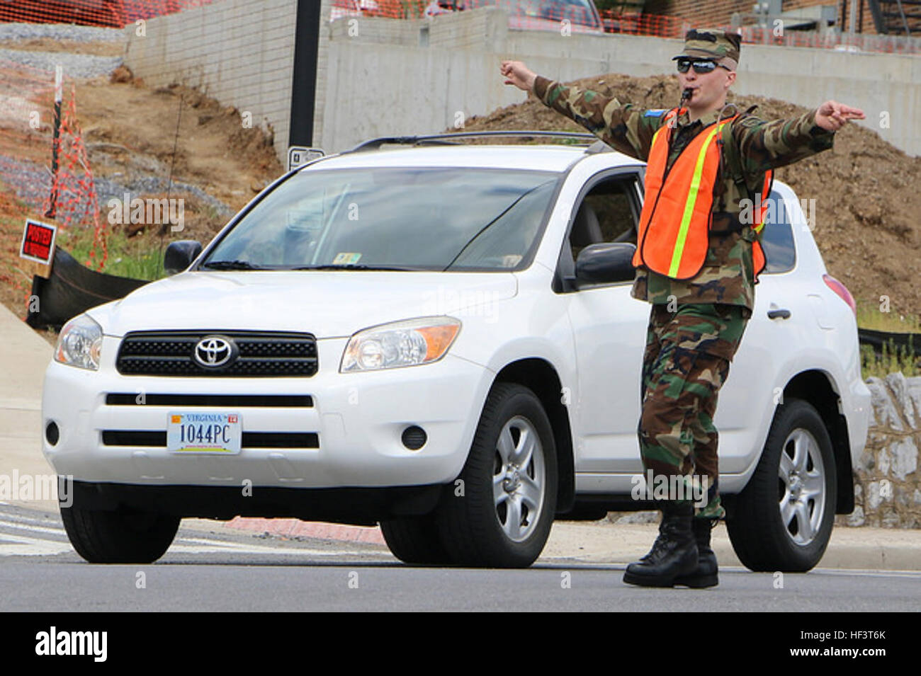 A member of the Virginia Defense Force operates a traffic control point ...