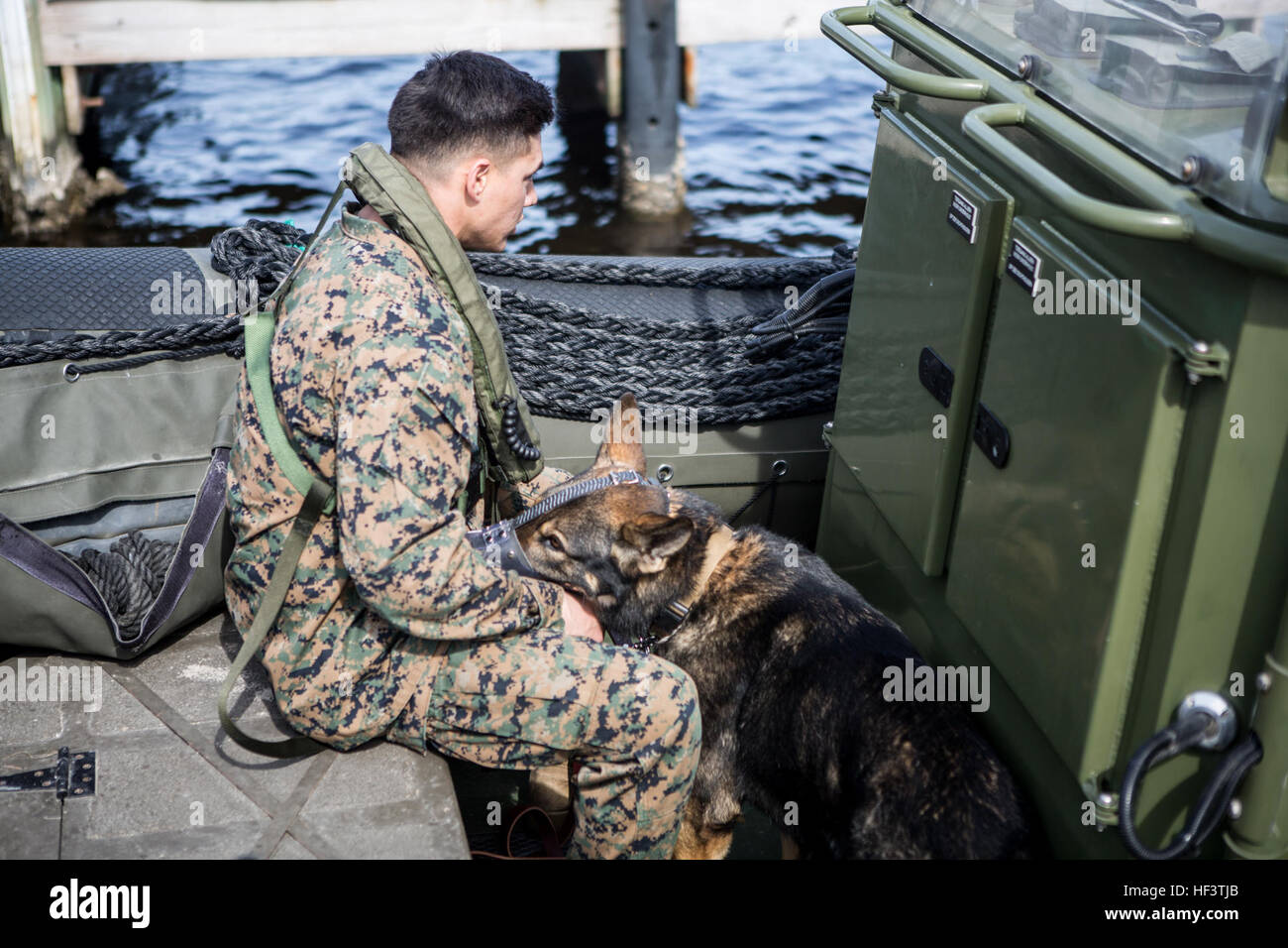 A U.S. Marine Corps dog handler with Headquarters and Support Battalion ...