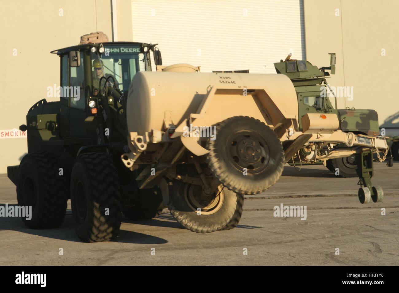 A tram operator from the 22nd Marine Expeditionary Unit moves a water ...