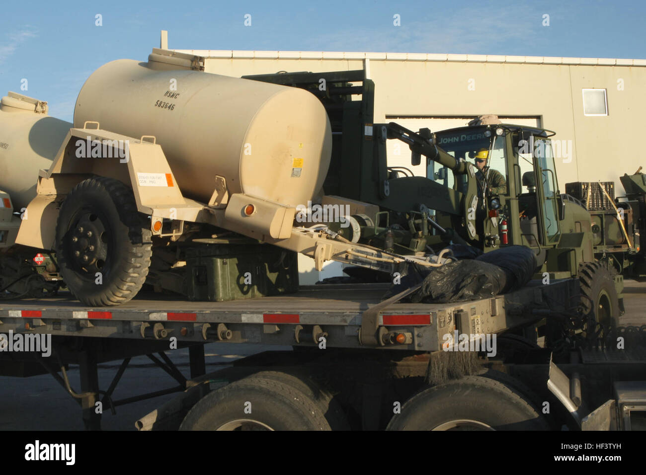 A tram operator from the 22nd Marine Expeditionary Unit loads a water ...