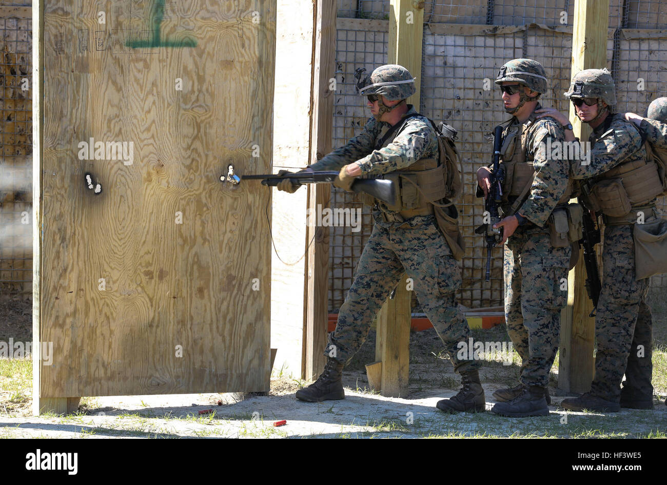 A Marine with 2nd Combat Engineer Battalion breaches a door with a ...