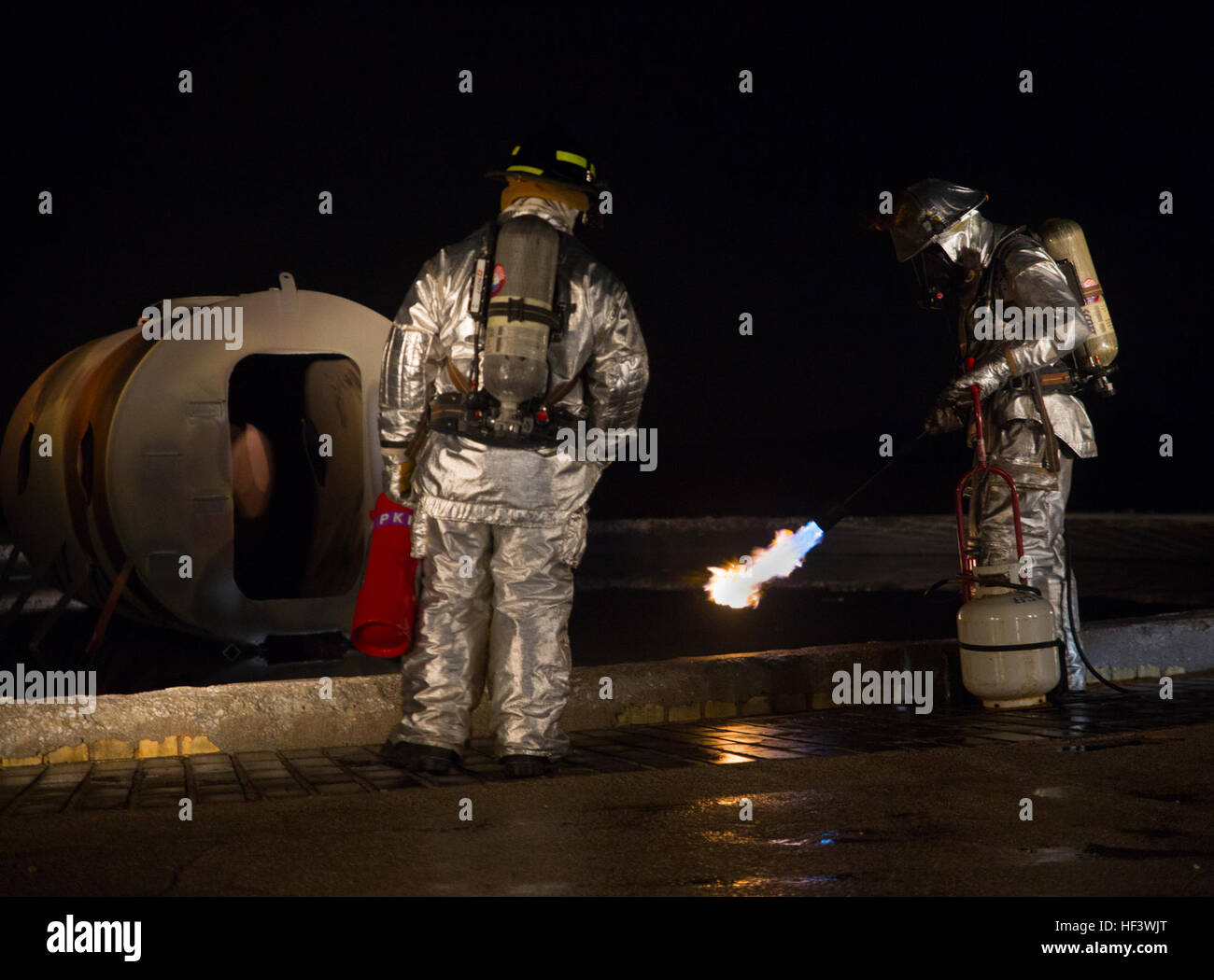 Marines with Aircraft Rescue Fire Fighting light a fuel fire in a ...