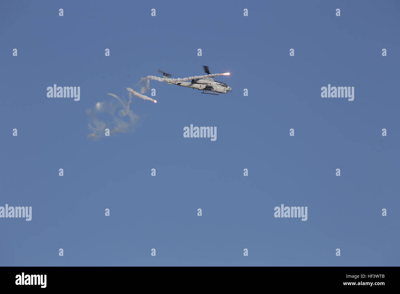 A U.S. Marine Corps AH-1W Super Cobra launches flares during an ...