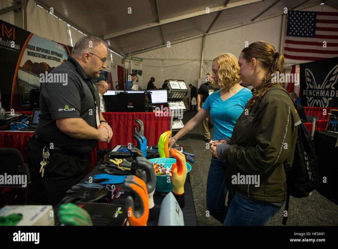 Rodney Soltow, left, exhibitor with Showa Best Glove, explains the ...