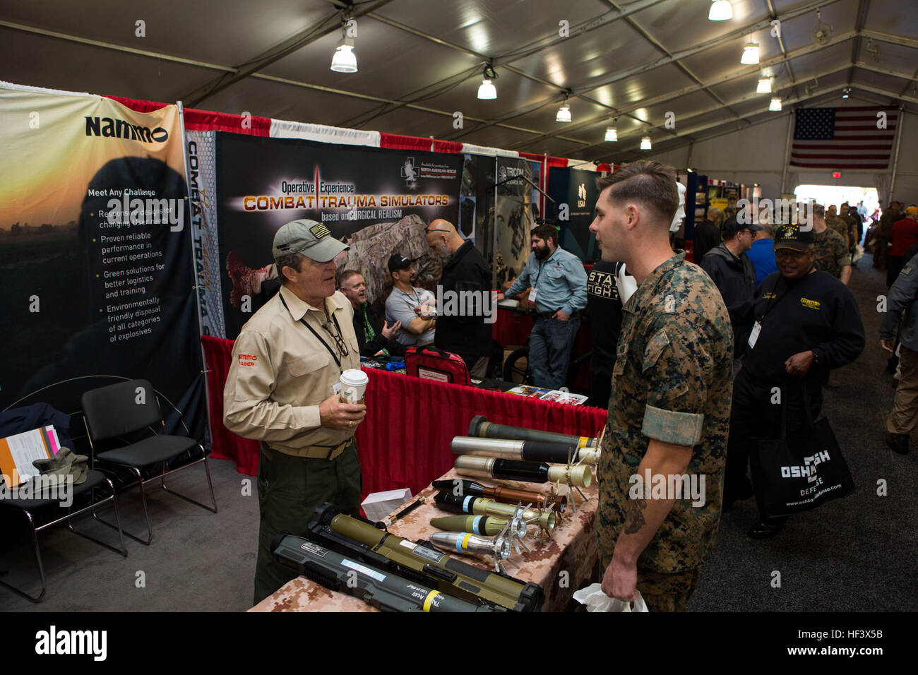 An exhibitor with Nammo Talley, left, speaks with U.S. Marine Corps Cpl ...