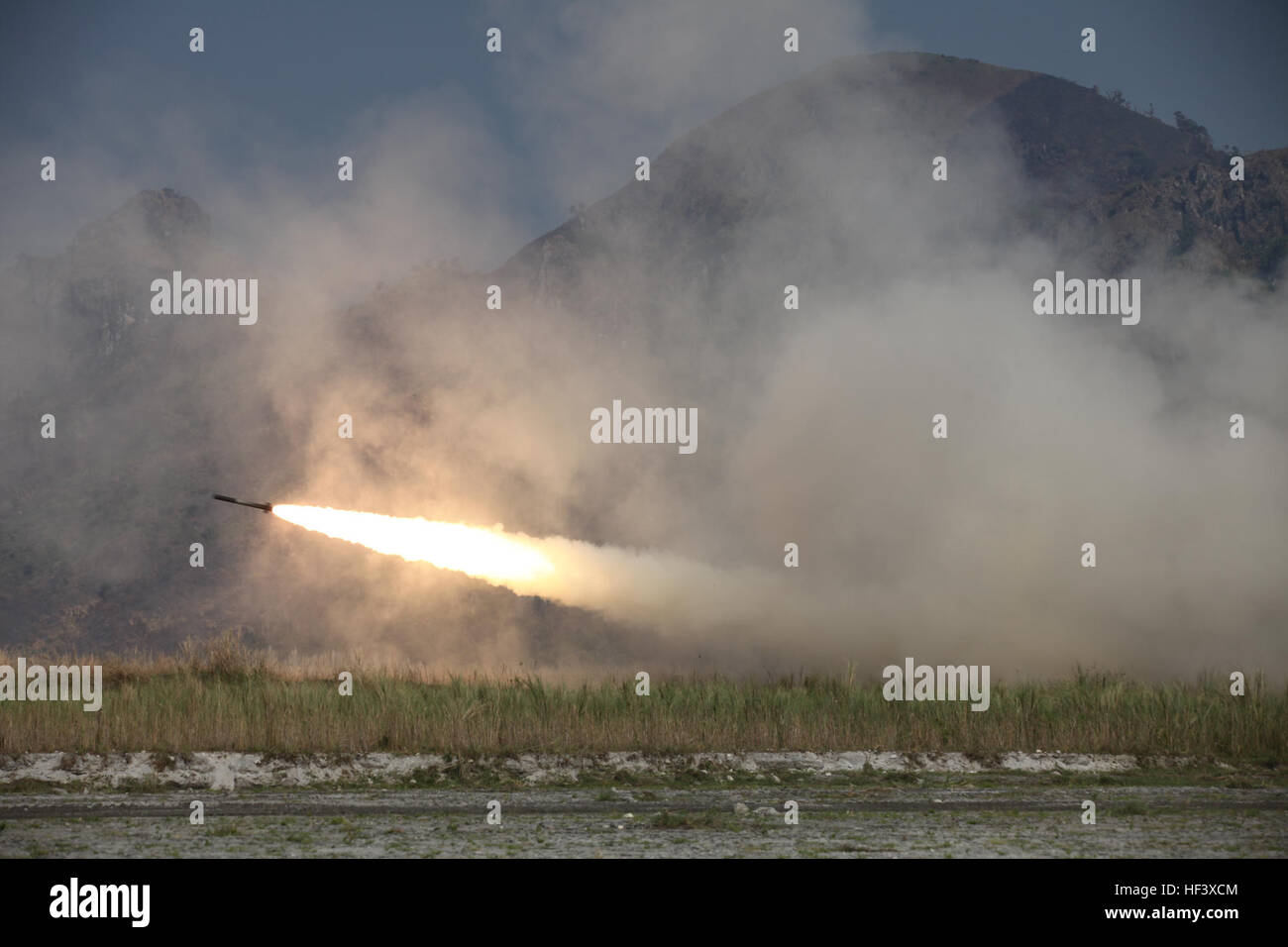 A U.S. Marines High Mobility Artillery Rocket System fires a rocket ...