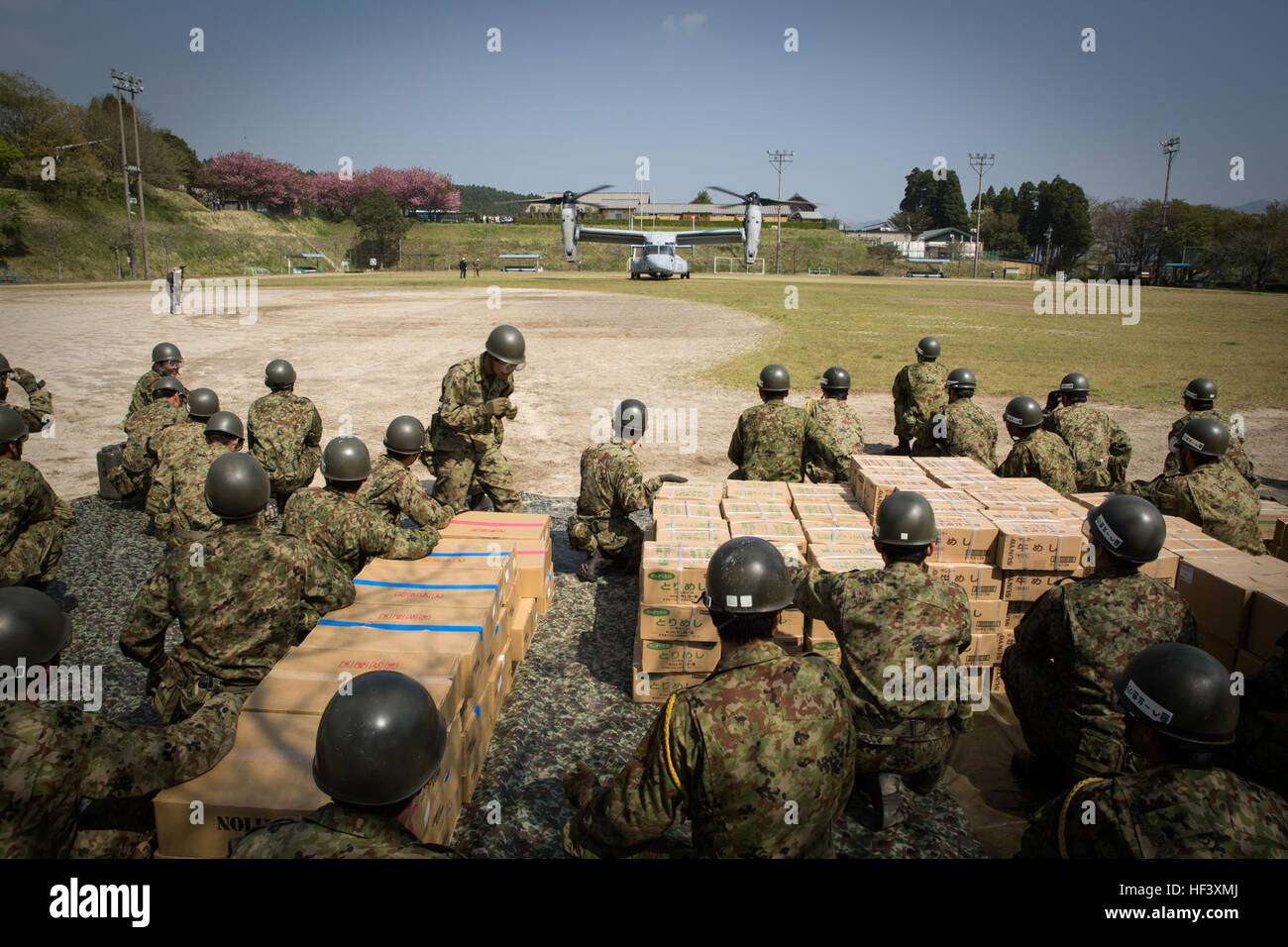 Japan Ground Self Defense Force Soldiers wait by supplies after ...
