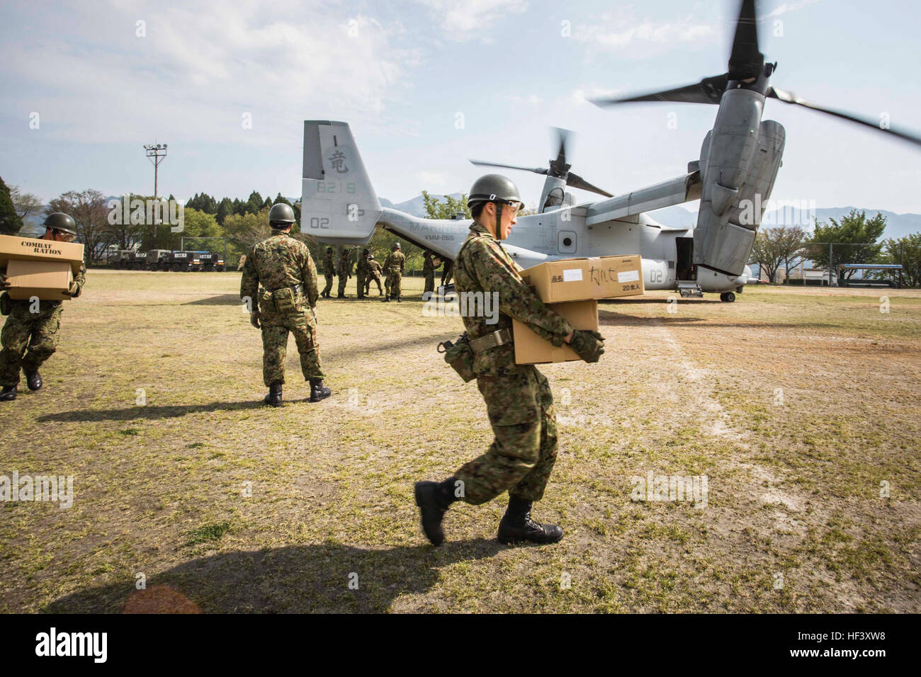 Japan Ground Self Defense Force personnel carry supplies from a U.S ...