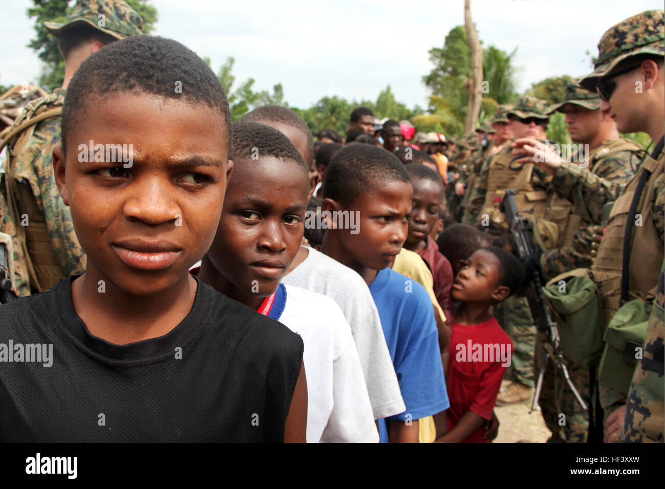 Haitian children are first in line at a humanitarian aid distribution ...