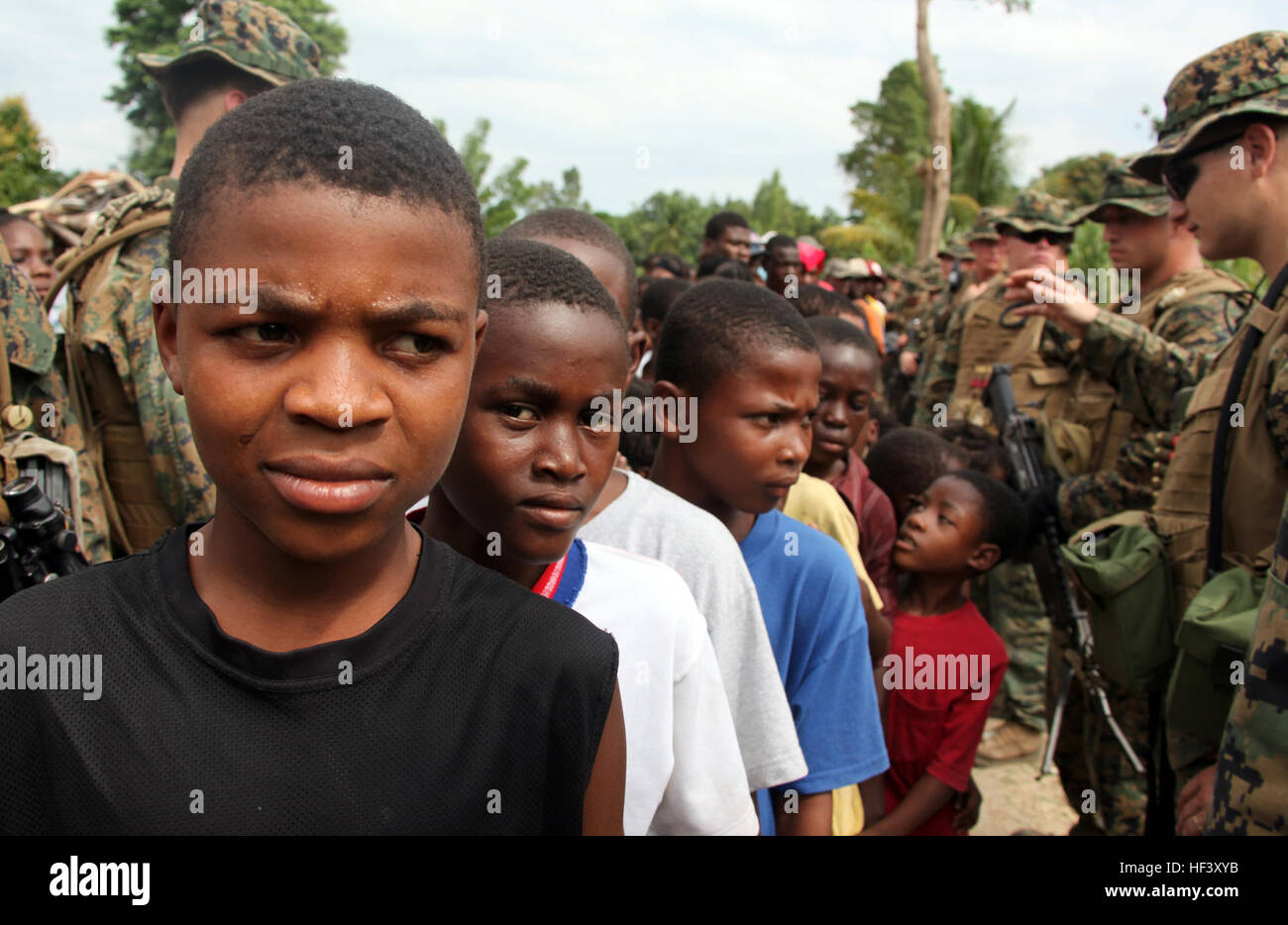Haitian children are first in line at a humanitarian aid distribution ...
