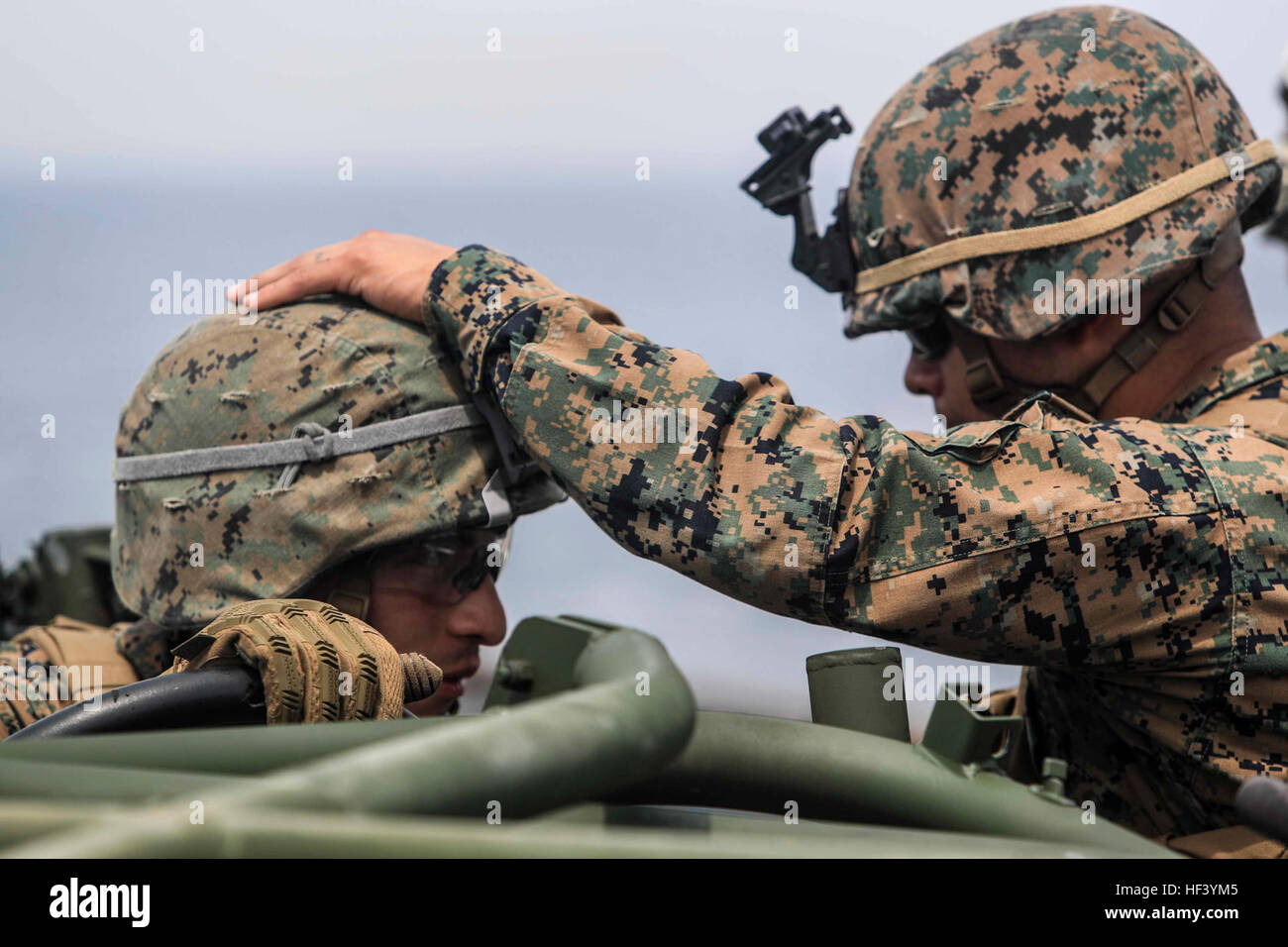 U.S. Marine Corps Sgt. Seth Garza, left, communications chief, talks to ...